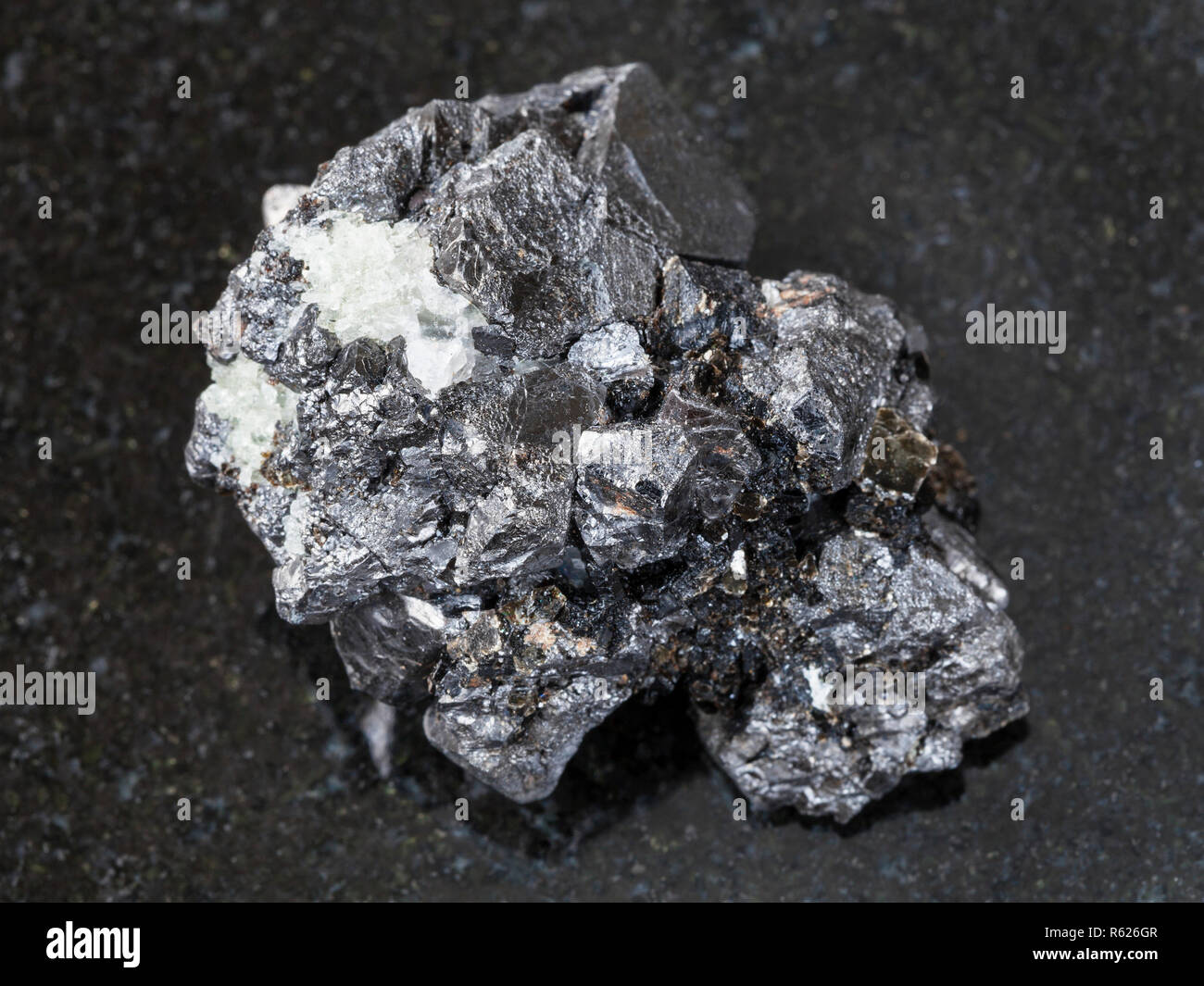 raw crystalline Magnetite stone on dark Stock Photo - Alamy