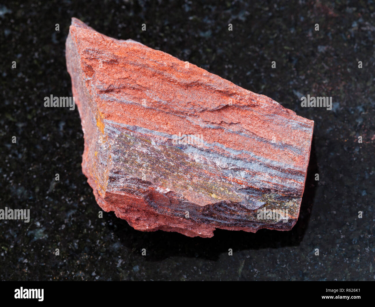 rough ferruginous quartzite stone on dark Stock Photo - Alamy