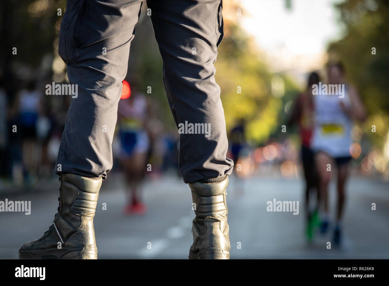 Security member guarding street for sports event Stock Photo - Alamy