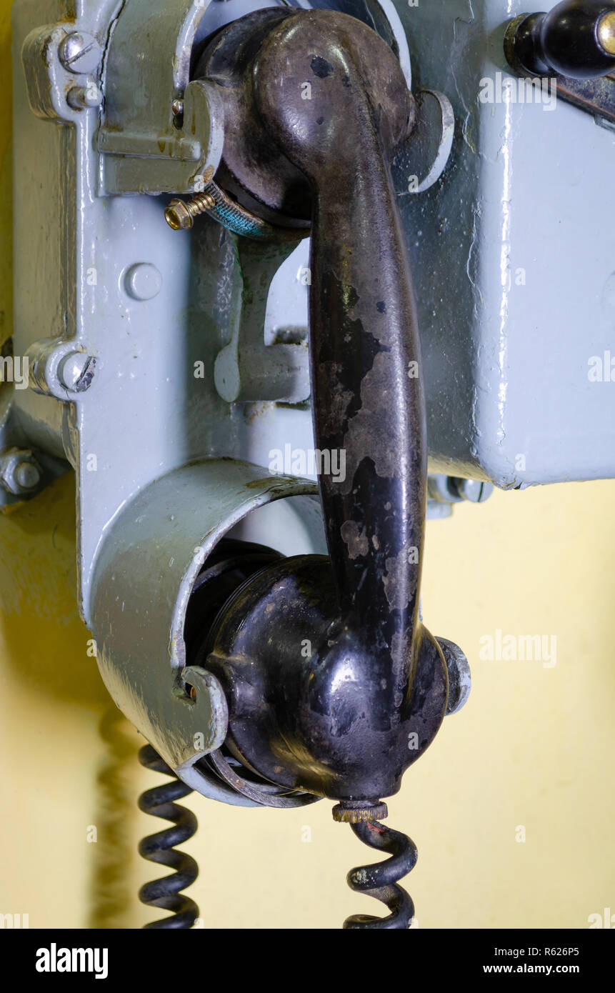 A worn and scratched old ship's telephone shows its years of service ...