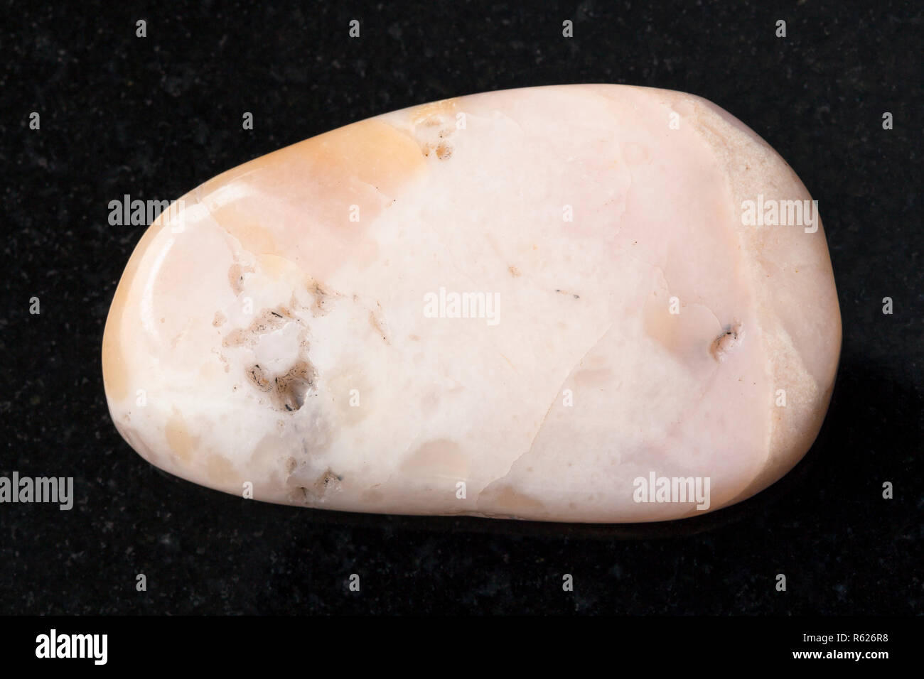 polished pink opal gemstone on dark background Stock Photo - Alamy