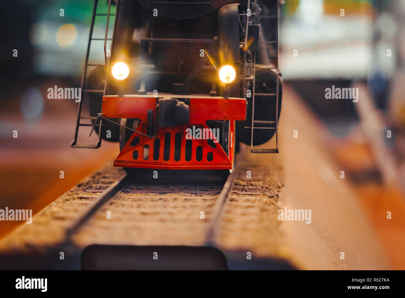 Black model Locomotive on track layout with headlamp Stock Photo - Alamy