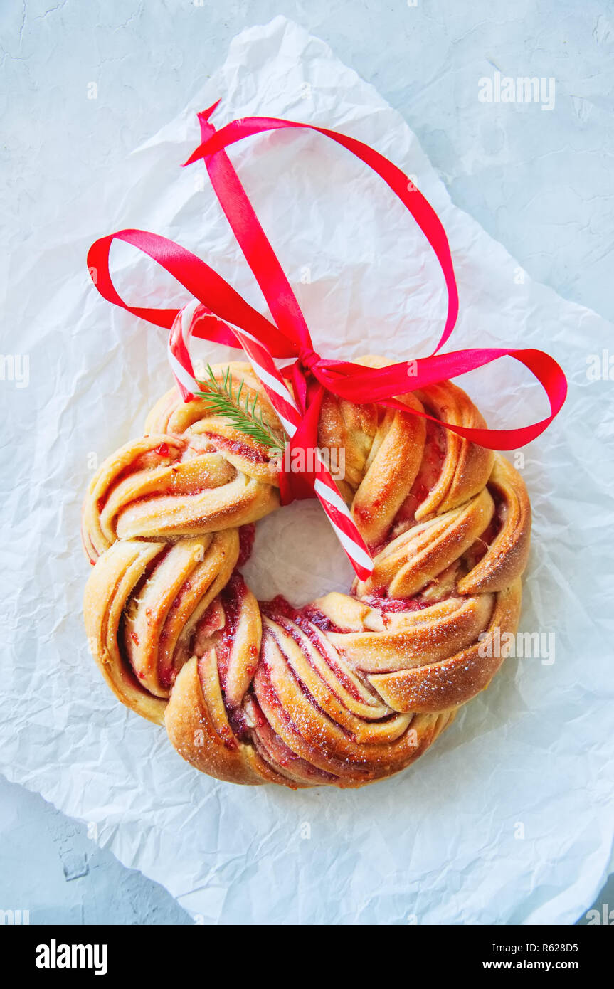 Raspberry jam swirl brioche wreath with candy cane and red ribbo Stock ...