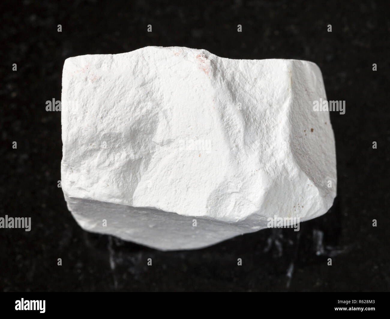 raw chalkstone on dark background Stock Photo - Alamy