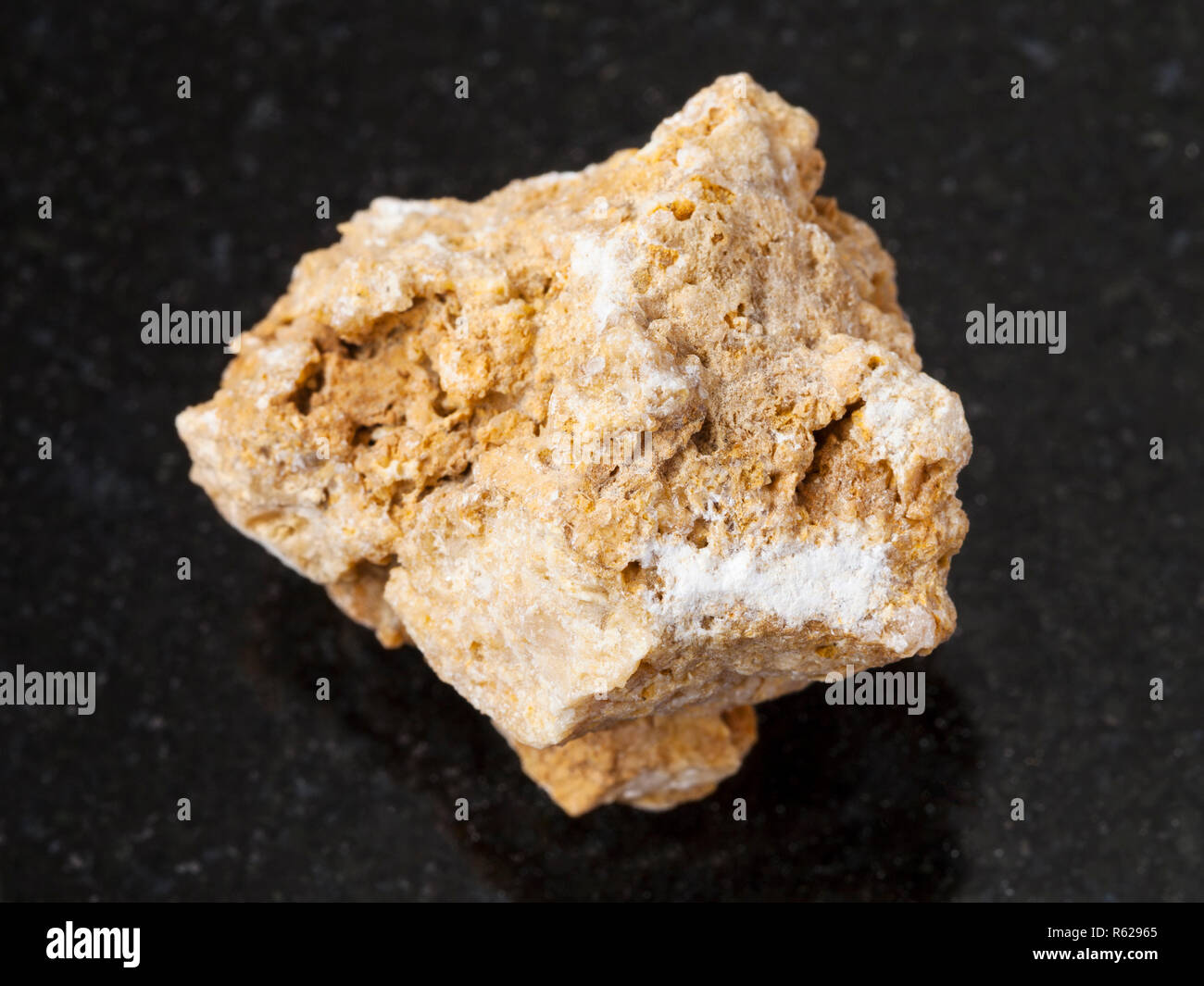 raw travertine stone on dark background Stock Photo - Alamy