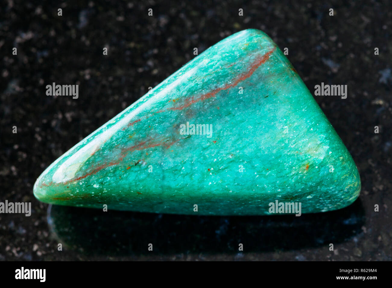 tumbled fuchsite (chrome mica) gemstone on dark Stock Photo - Alamy