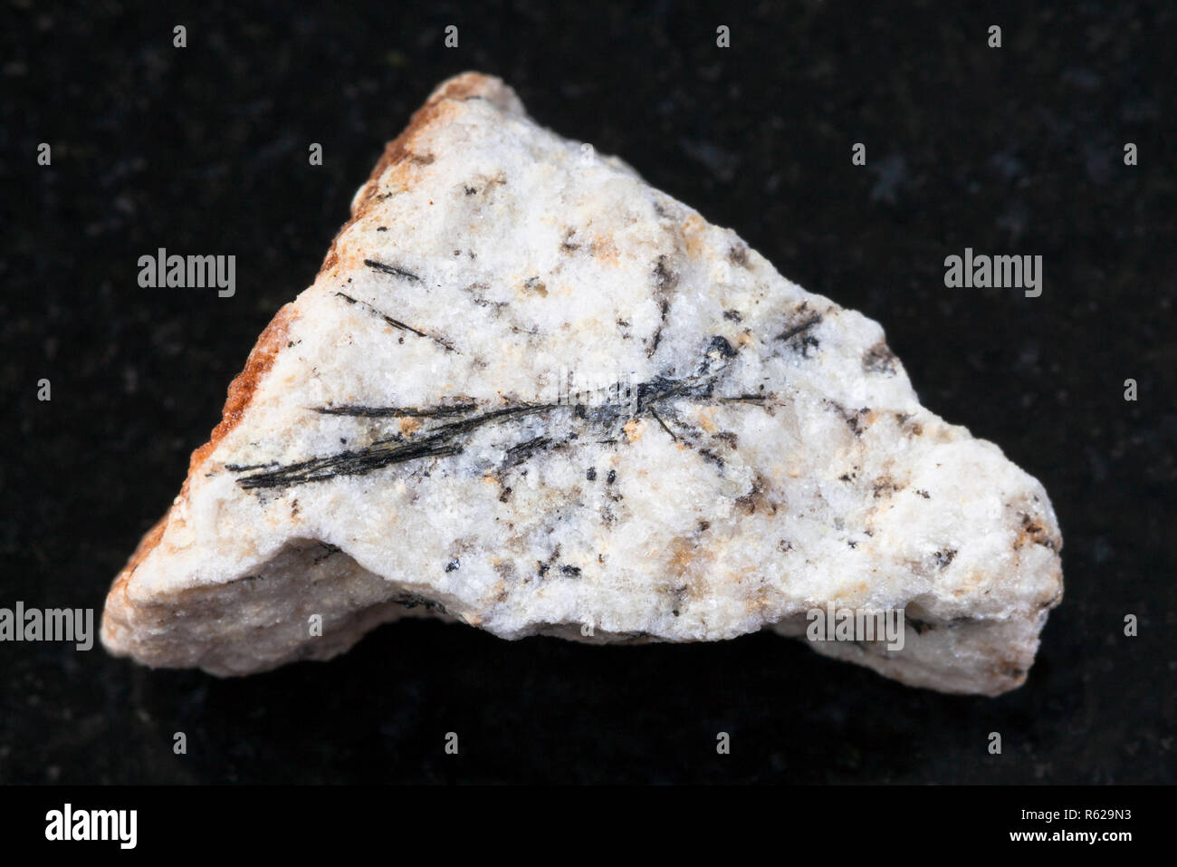 Ludwigite crystals in rough stone on dark Stock Photo - Alamy