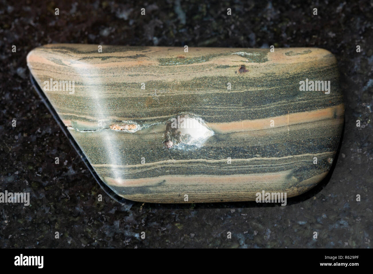 polished marl shale stone on dark background Stock Photo - Alamy
