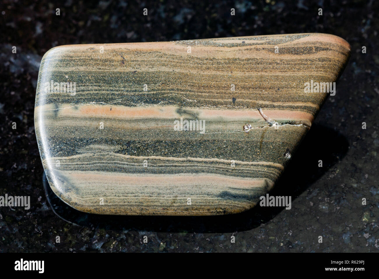 tumbled marl shale stone on dark background Stock Photo - Alamy