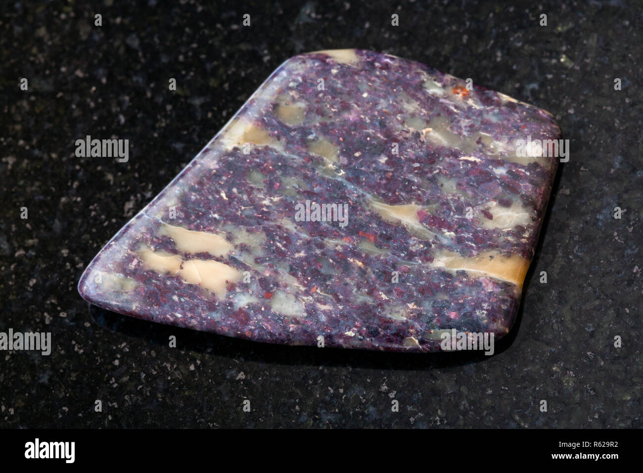 tumbled Alunite stone on dark background Stock Photo - Alamy