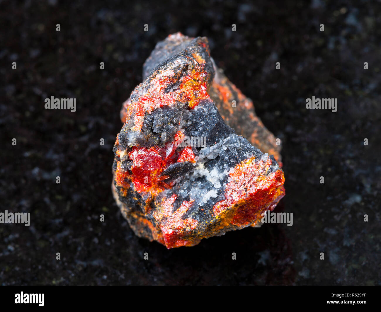 raw Realgar stone on dark background Stock Photo - Alamy