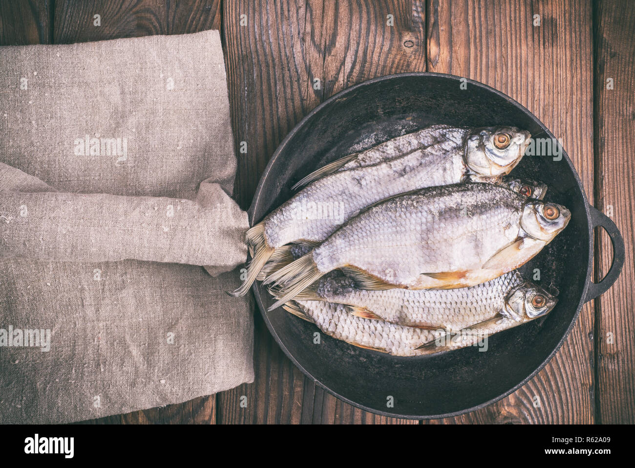 fish ram in a round black cast-iron frying pan Stock Photo - Alamy