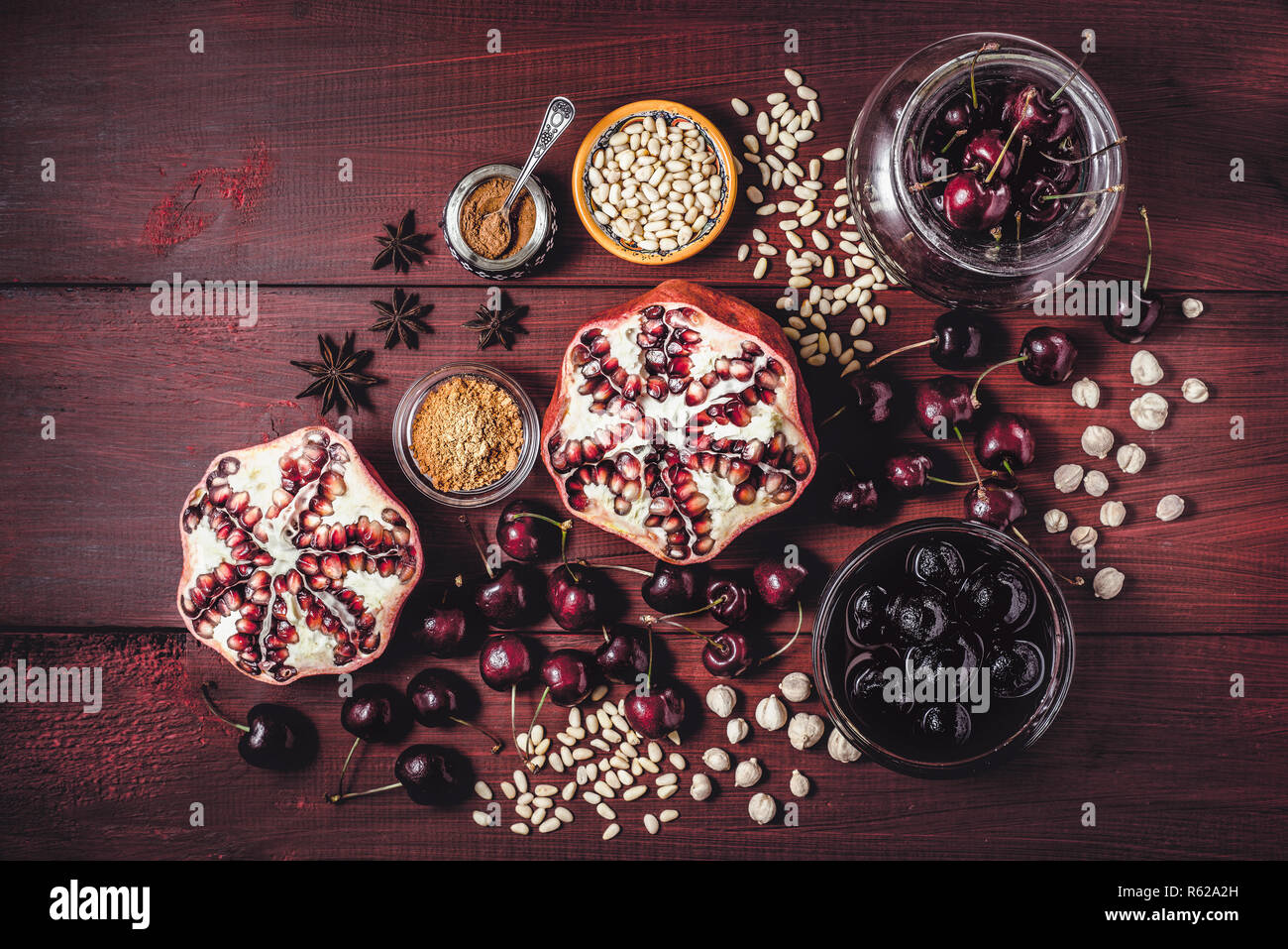 Different fruit and spices on the red wooden table. Concept of oriental ...