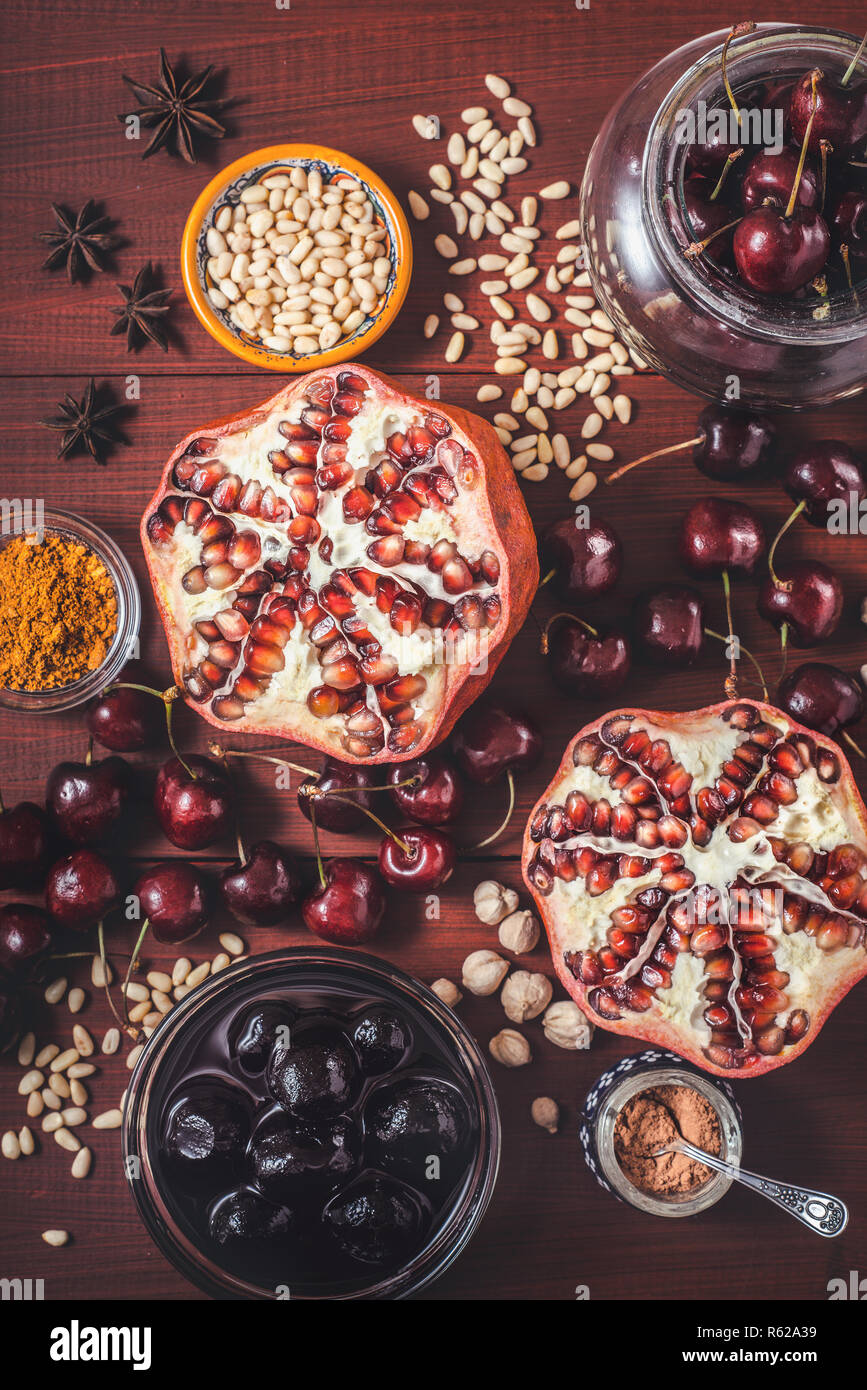Different fruit and spices on the red wooden table. Concept of oriental ...