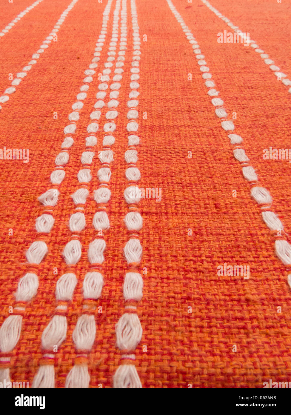 Close up of orange fabric patterns with white lines Stock Photo - Alamy