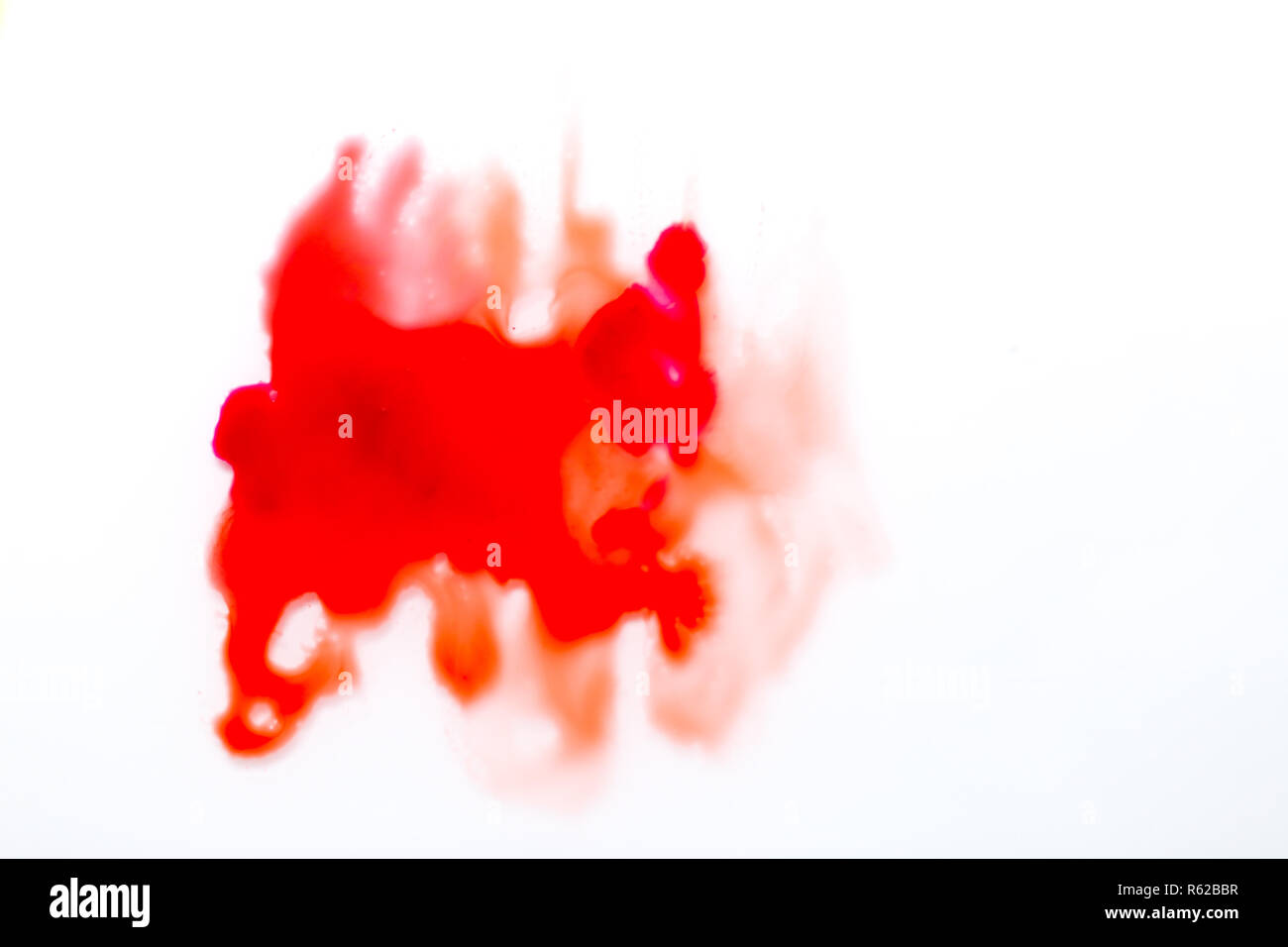 a spot of red paint on a white background. stain and spray Stock Photo ...