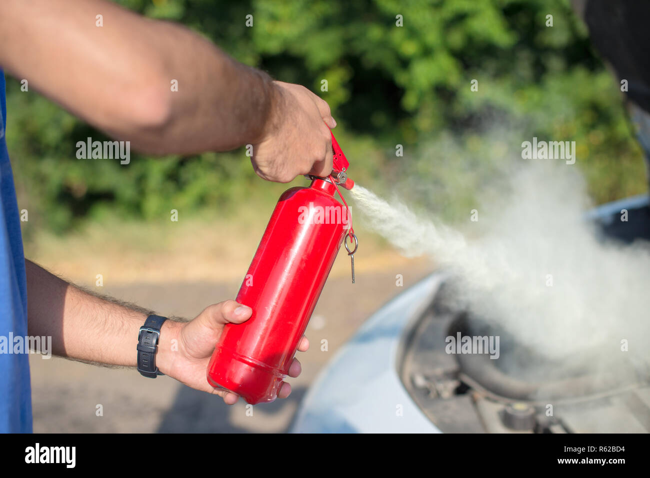Man using fire extinguisher hi-res stock photography and images - Alamy