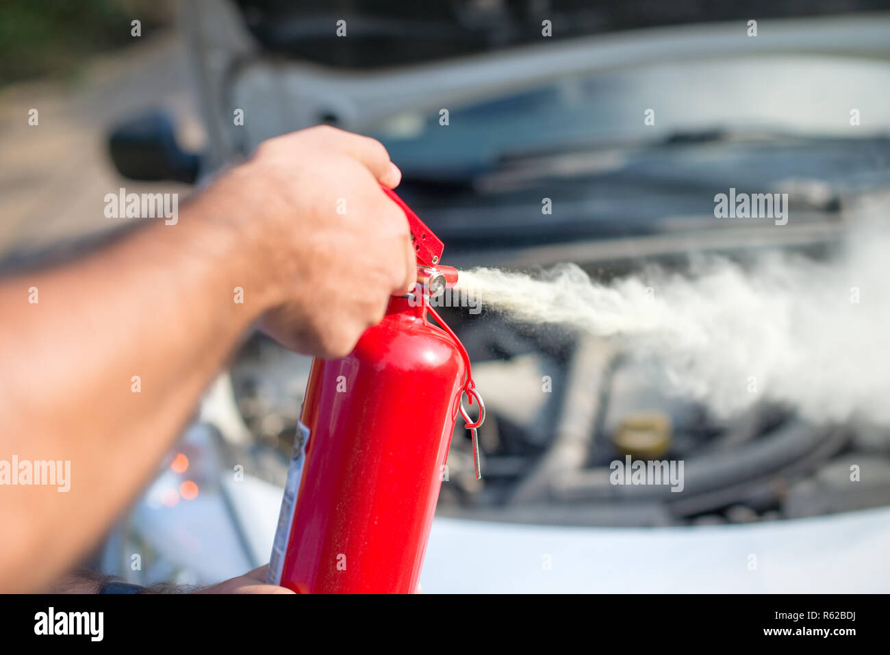 Man using fire extinguisher hi-res stock photography and images - Alamy