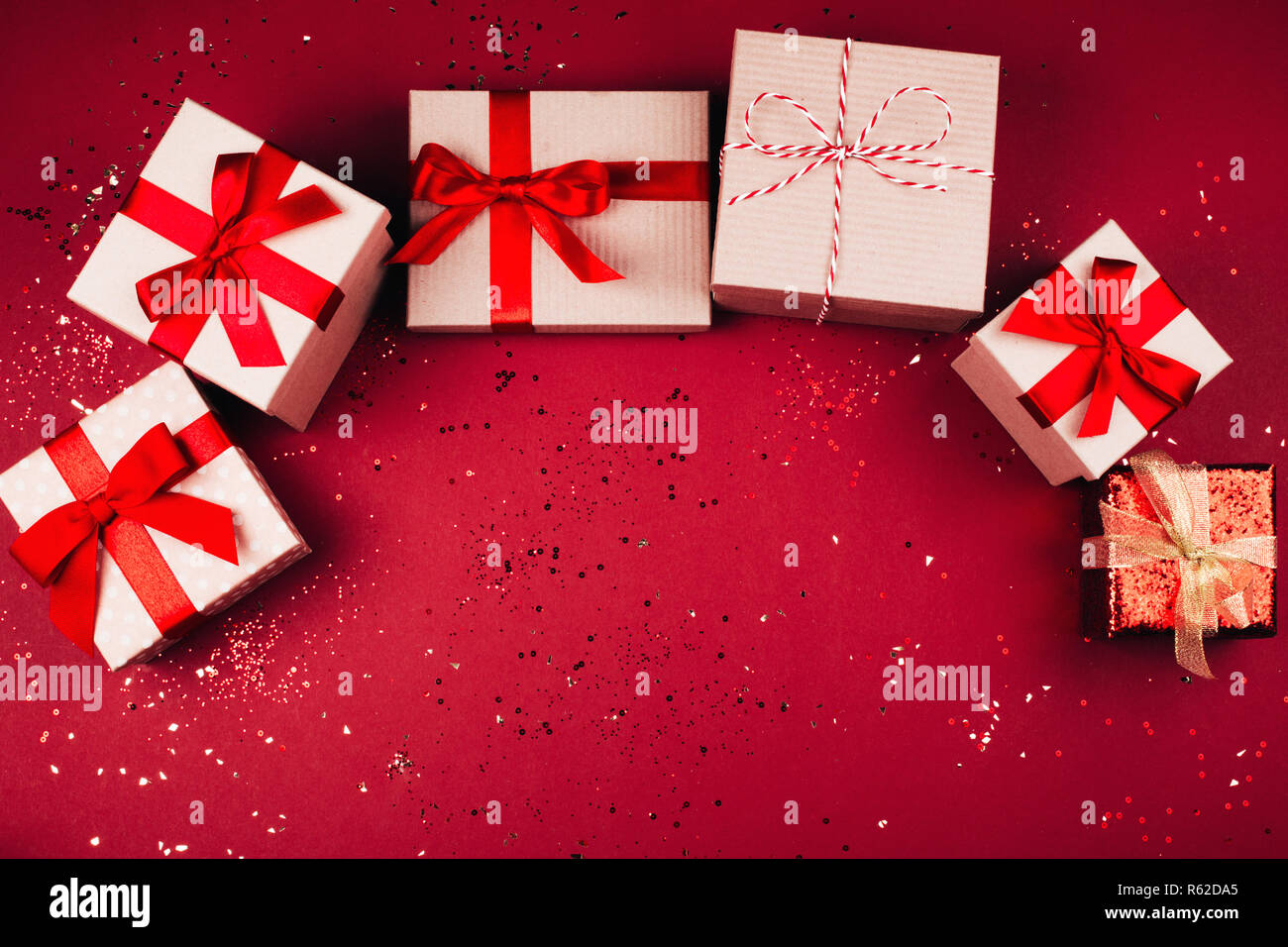 Many present boxes with red bow on red background. Flat lay style Stock ...