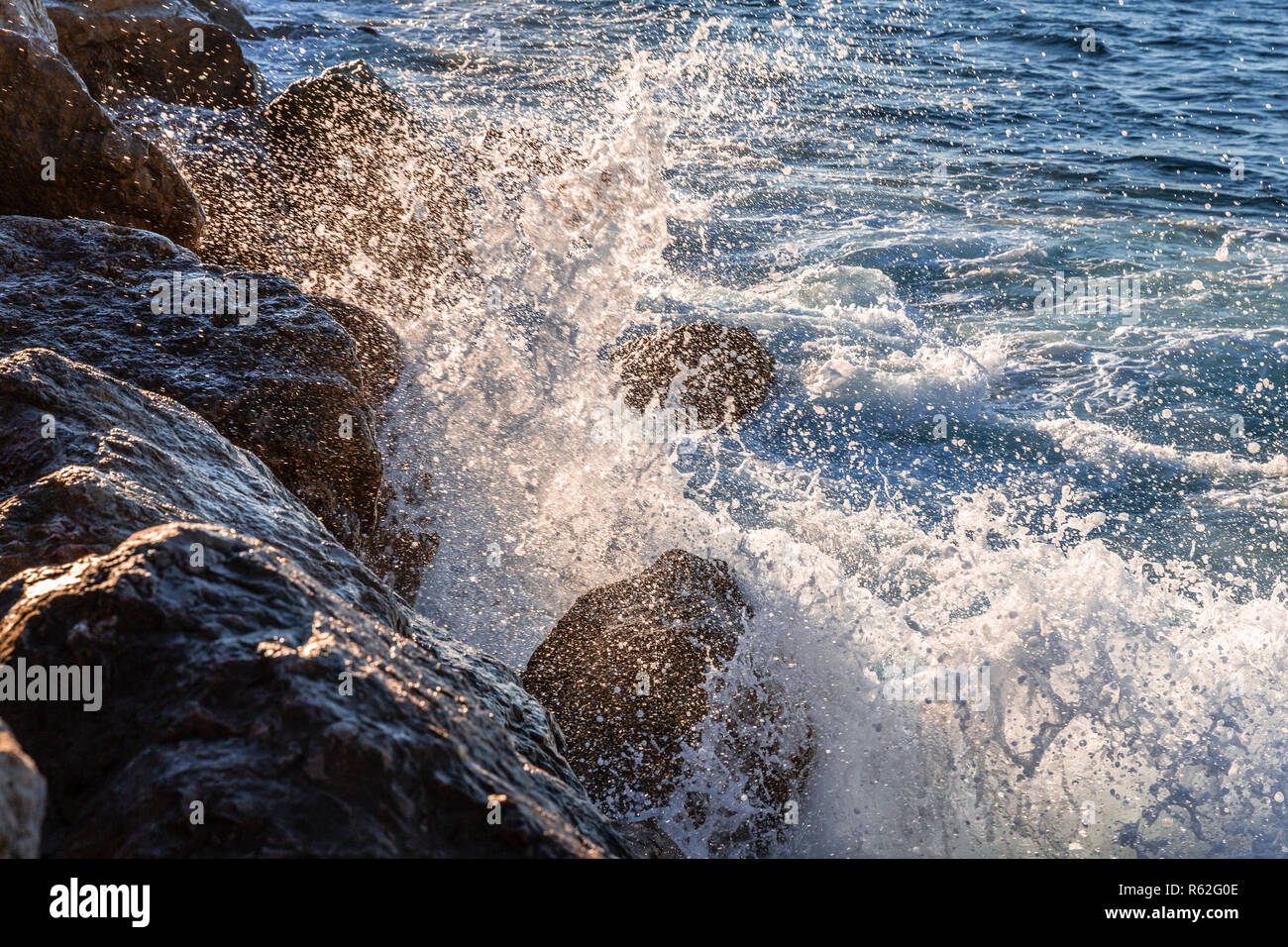 Moving wave and water of mediterranean sea touching rock beach making ...