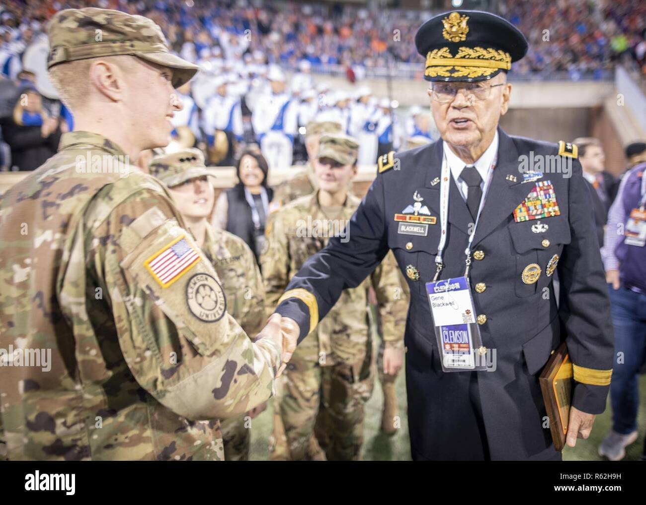 Retired U.S. Army Lt. Gen. Gene Blackwell shakes hands with an ROTC ...
