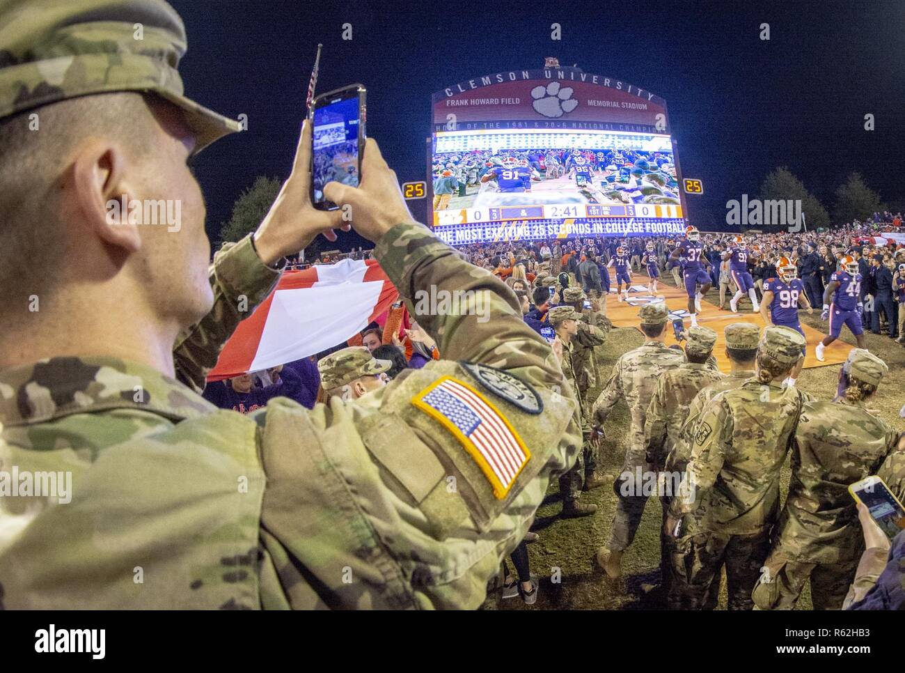 An Army ROTC cadet records the Clemson Tigers as they run down "The ...