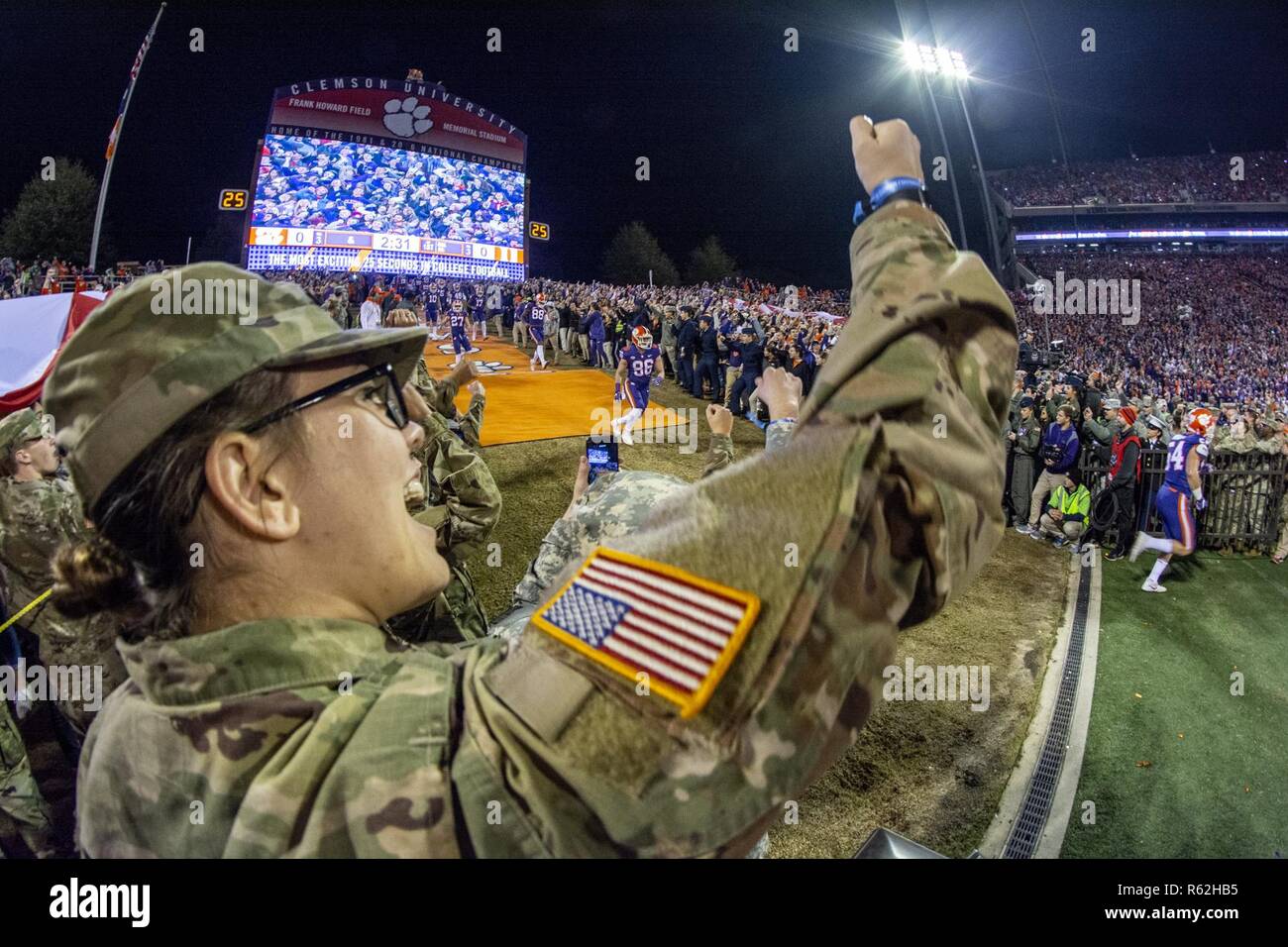 An Army ROTC cadet cheers as the Clemson University Tigers run down ...