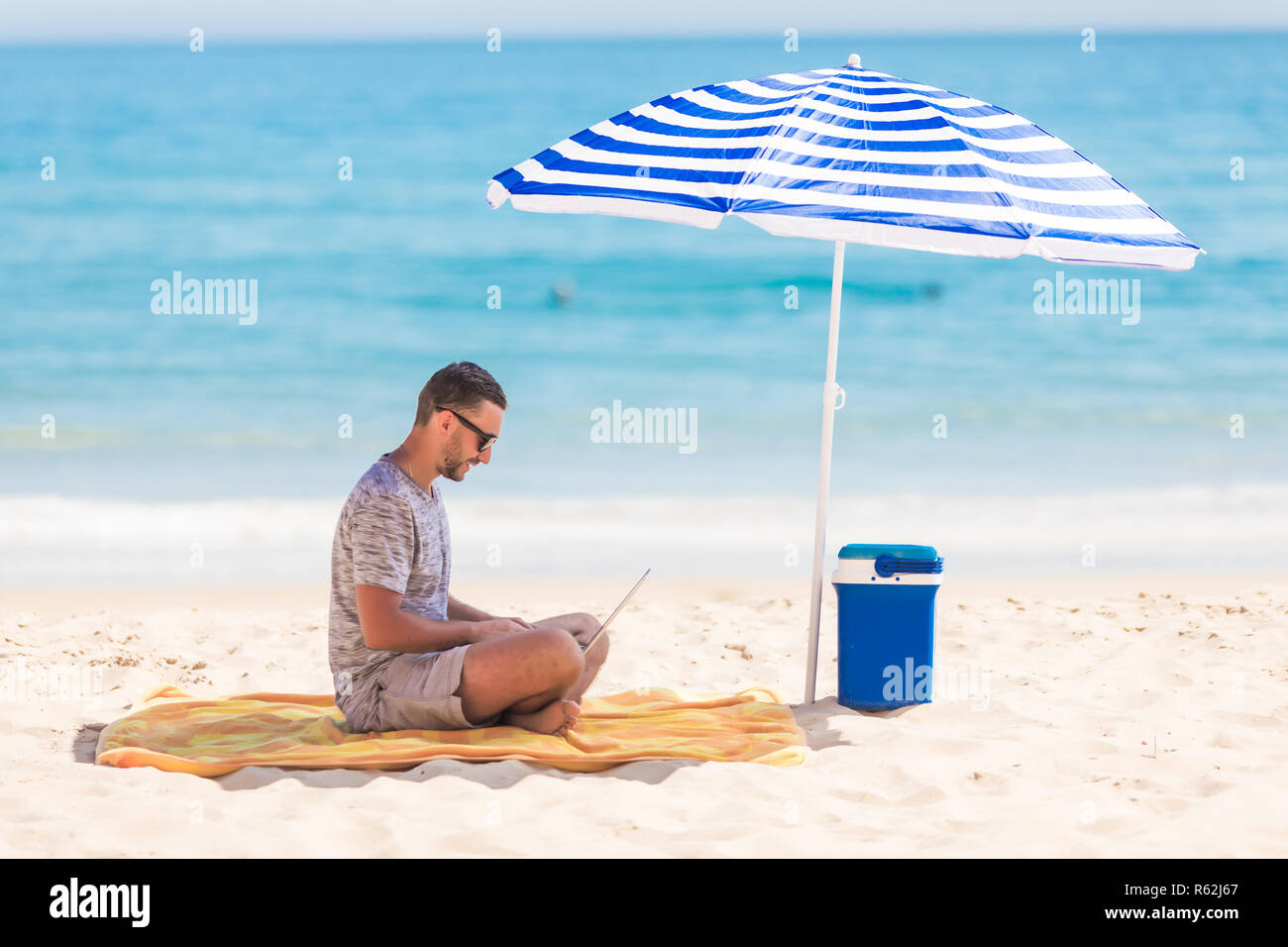 Businessman sitting deck chair laptop hi-res stock photography and ...