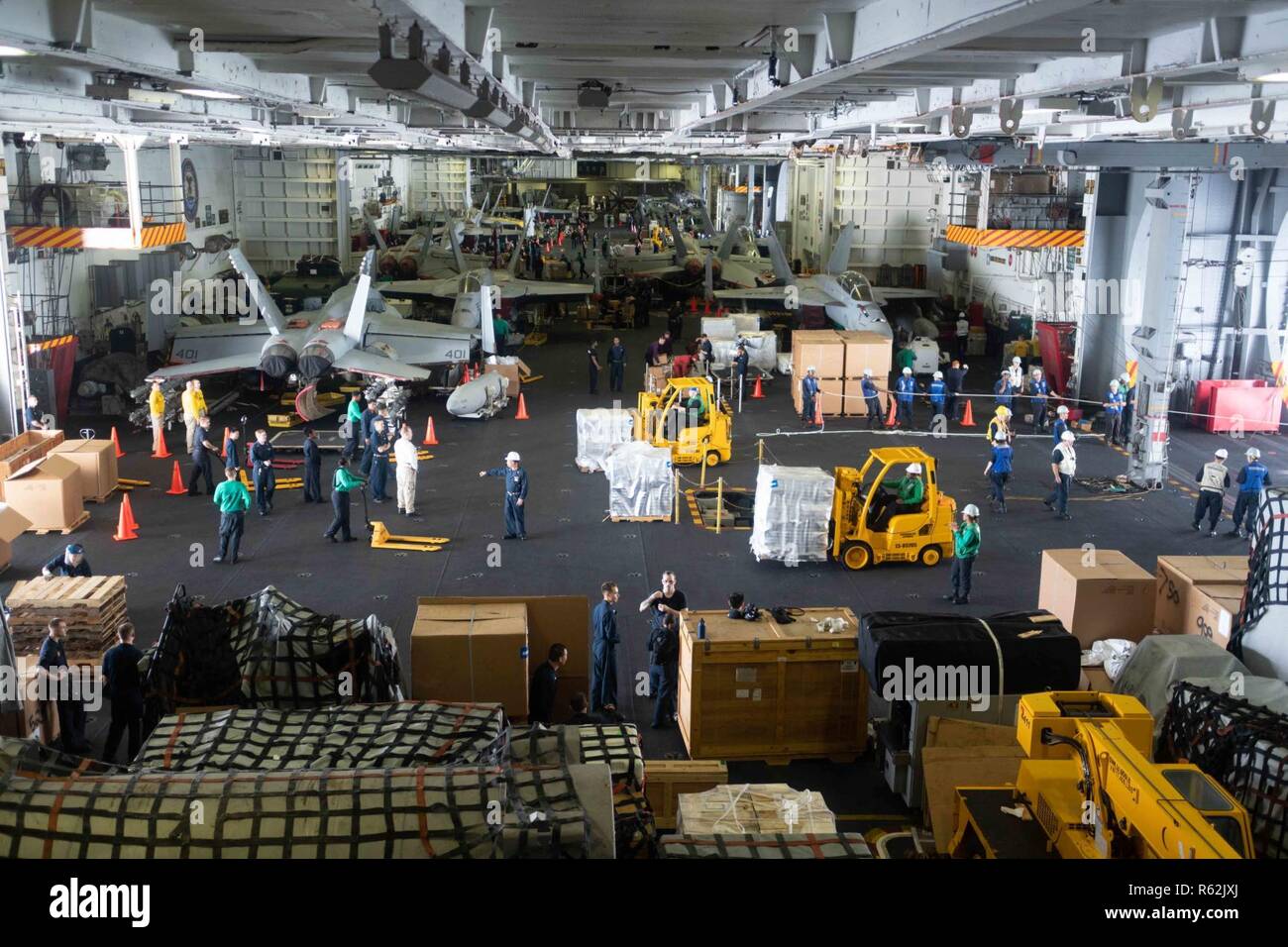 PACIFIC OCEAN (Nov. 19, 2018) Sailors organize cargo in the hangar bay ...