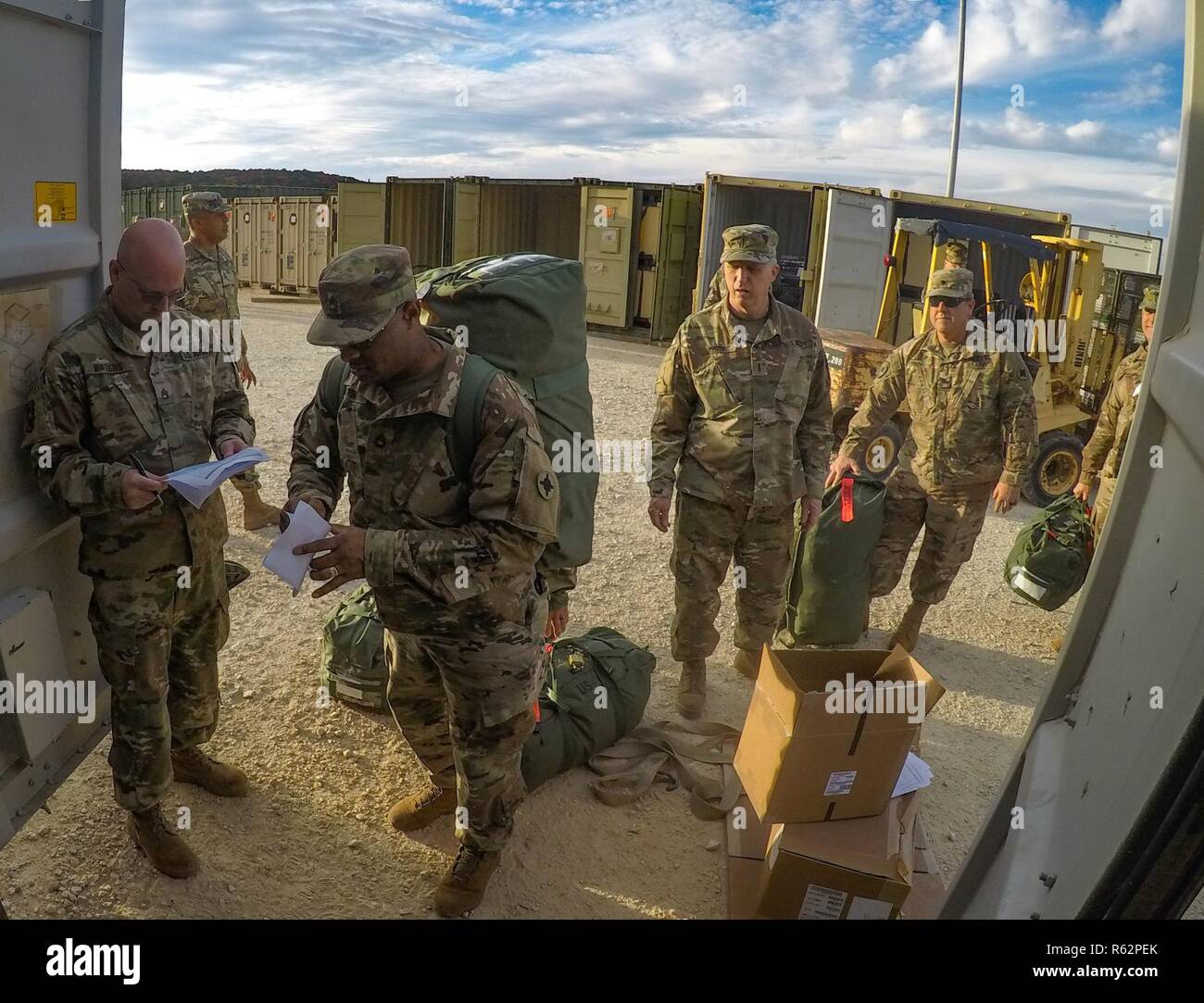 Soldiers of 184th Sustainment Command load gear into a shipping ...