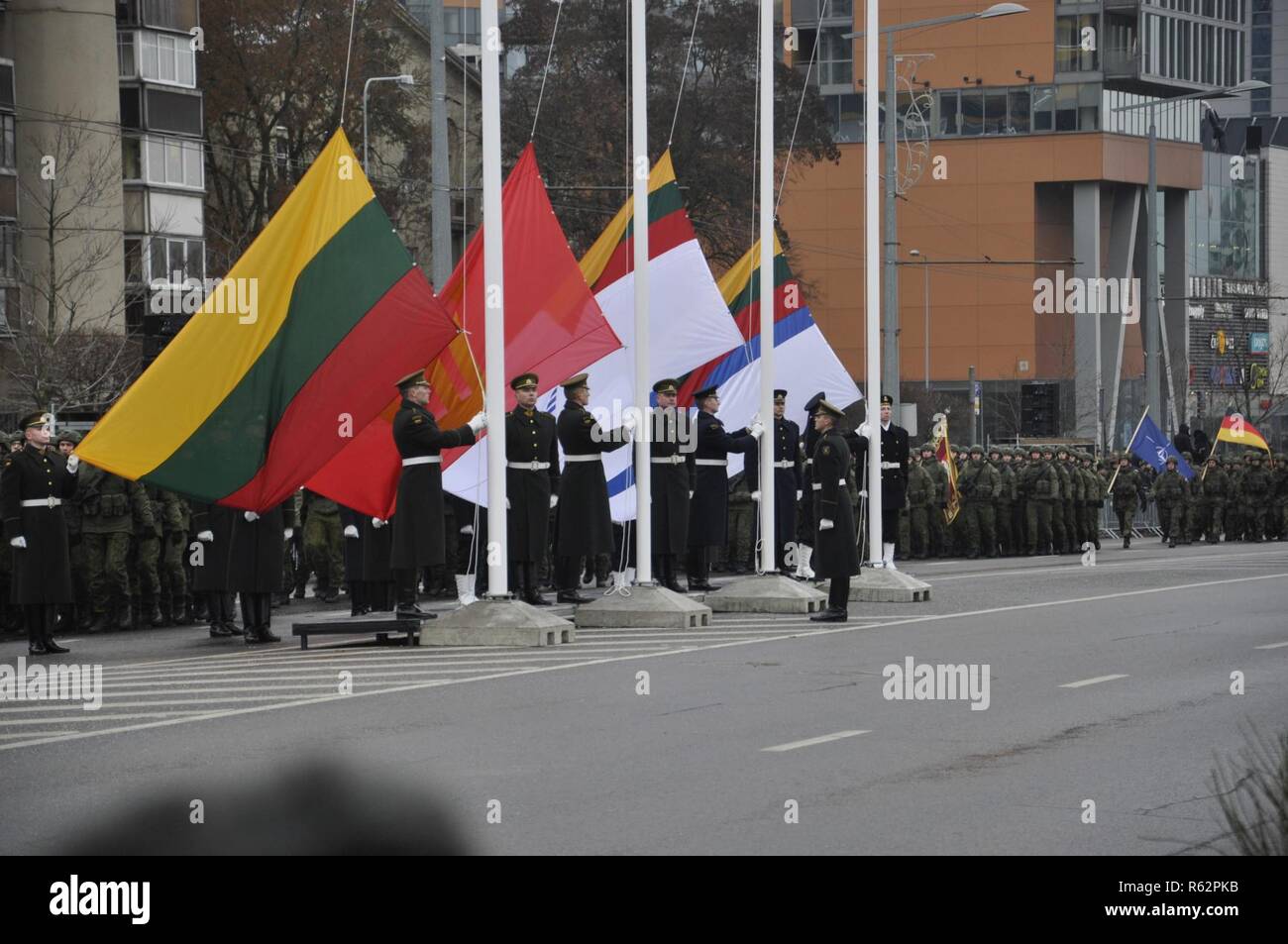 Lithuanian soldiers prepare to raise multiple country flags during the ...