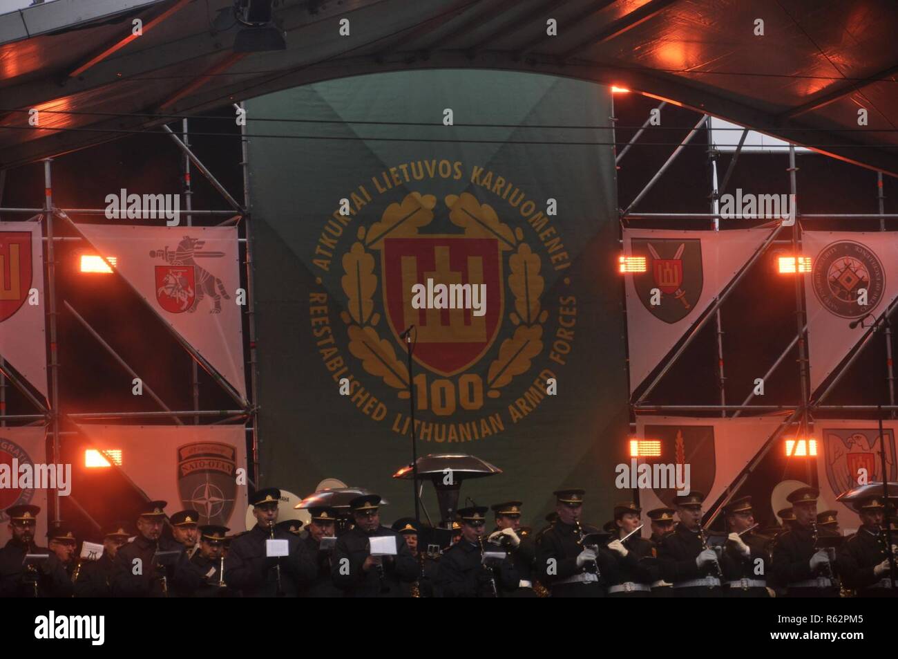 A commemorative Lithuanian flag drapes behind the multinational band ...
