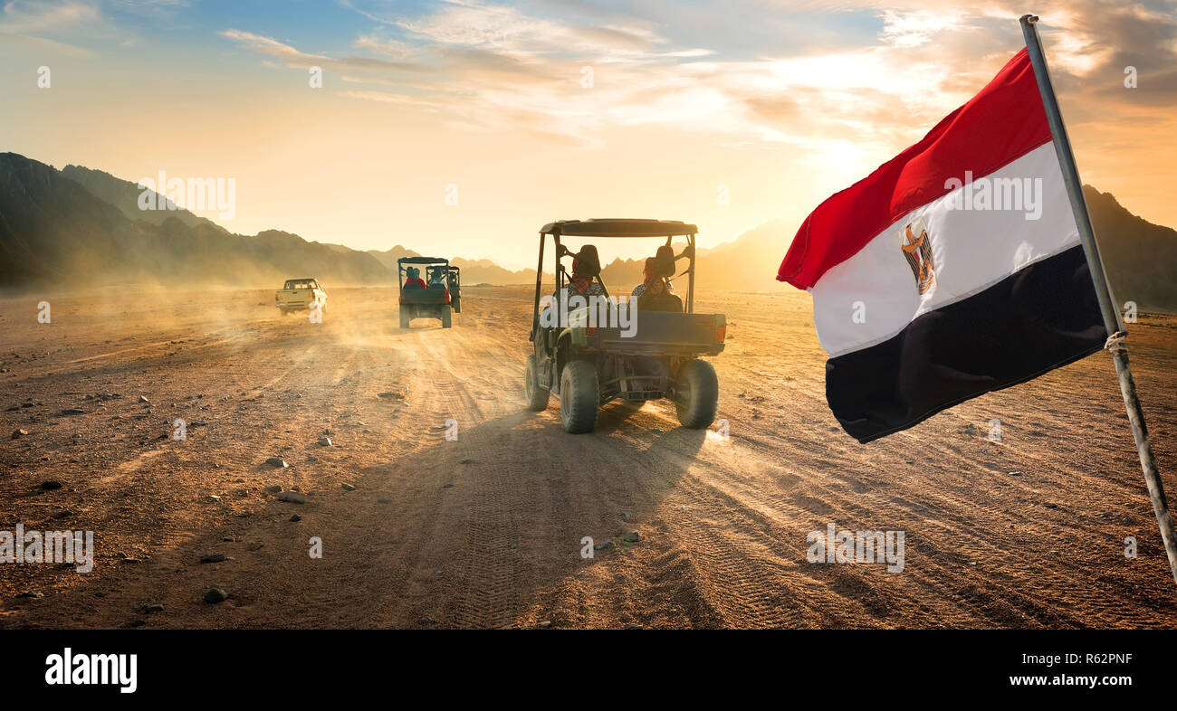 Flag and buggies in desert Stock Photo - Alamy