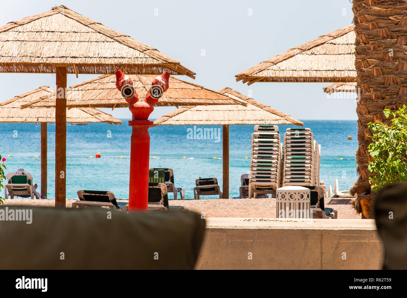 Beach composition, red hydrant fireplug looking like face of some ...