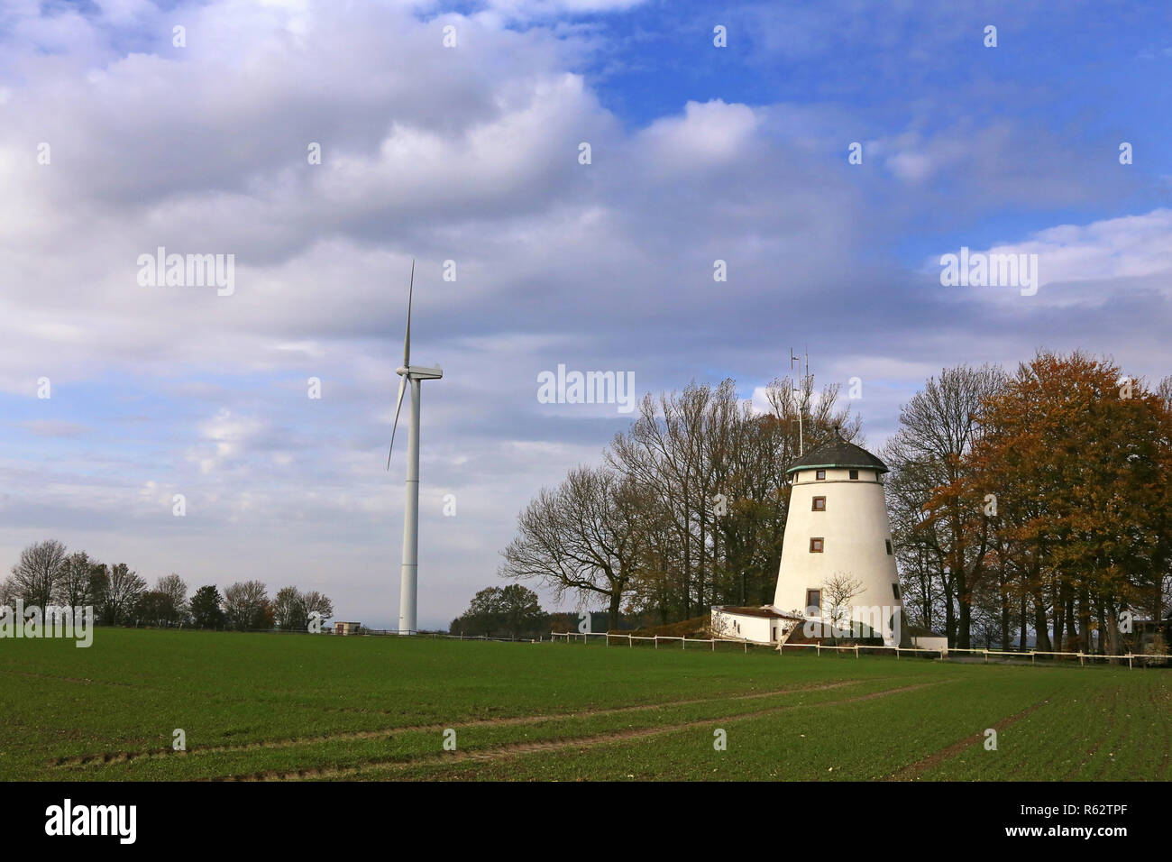 modern wind turbine next to historic windmill Stock Photo - Alamy