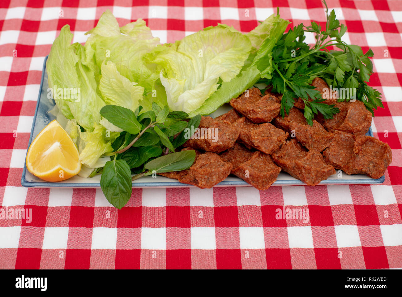 Traditional Turkish appetizer Cigkofte with lettuce,mint, parsley and ...
