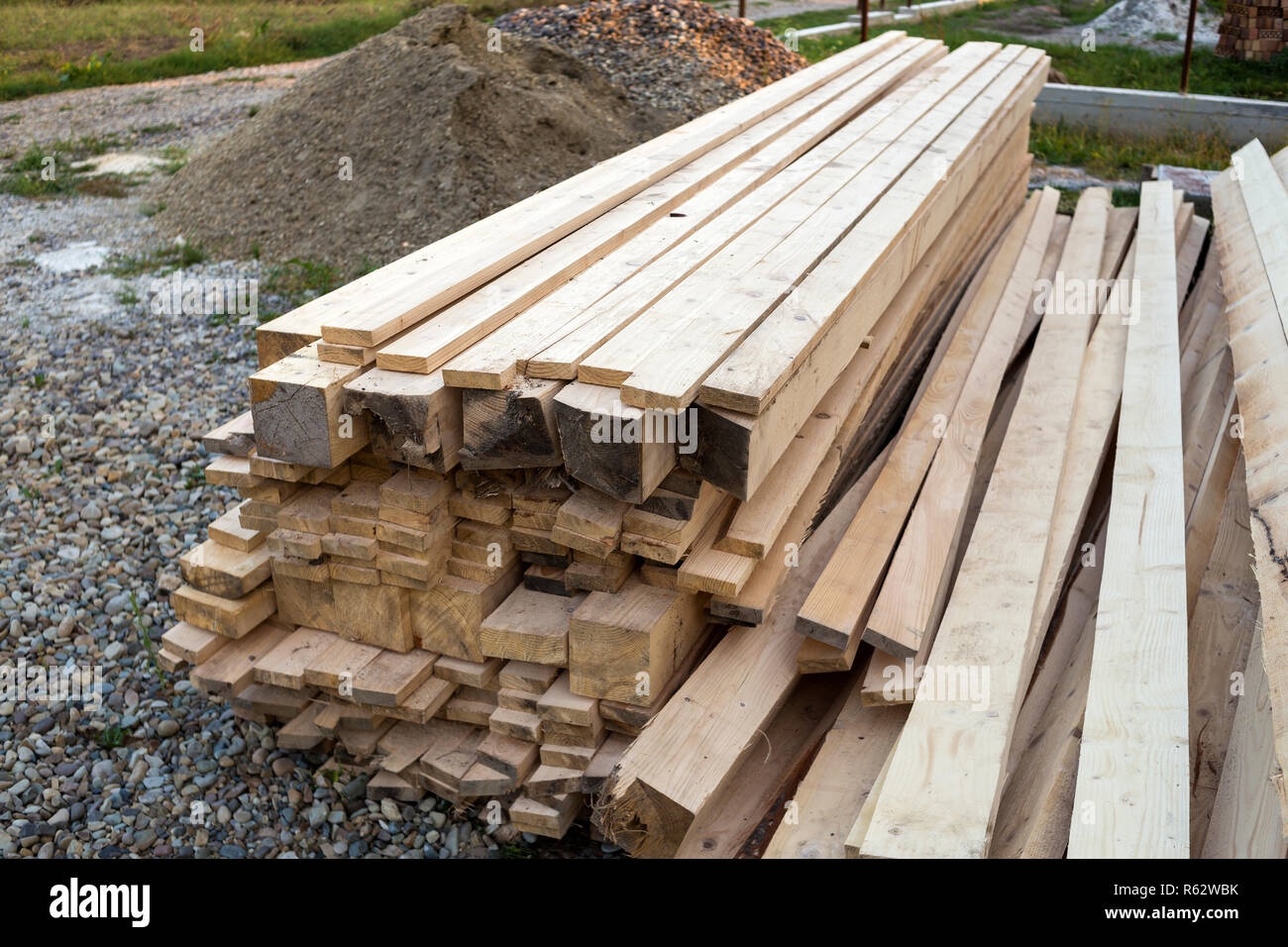 Stack of natural brown uneven rough wooden boards on building site ...