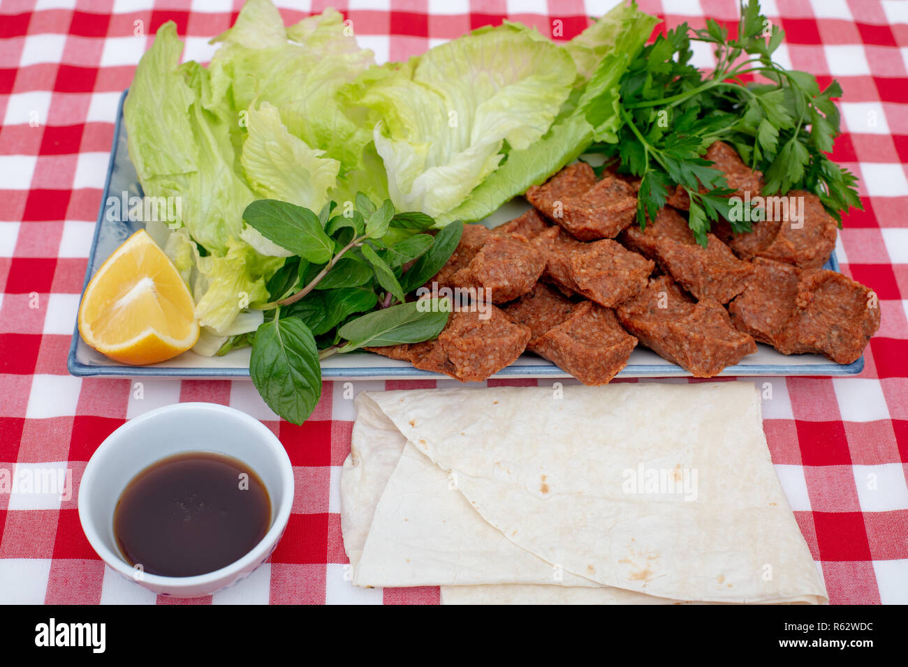 Traditional Turkish appetizer Cigkofte with lavash, ingredients are raw ...