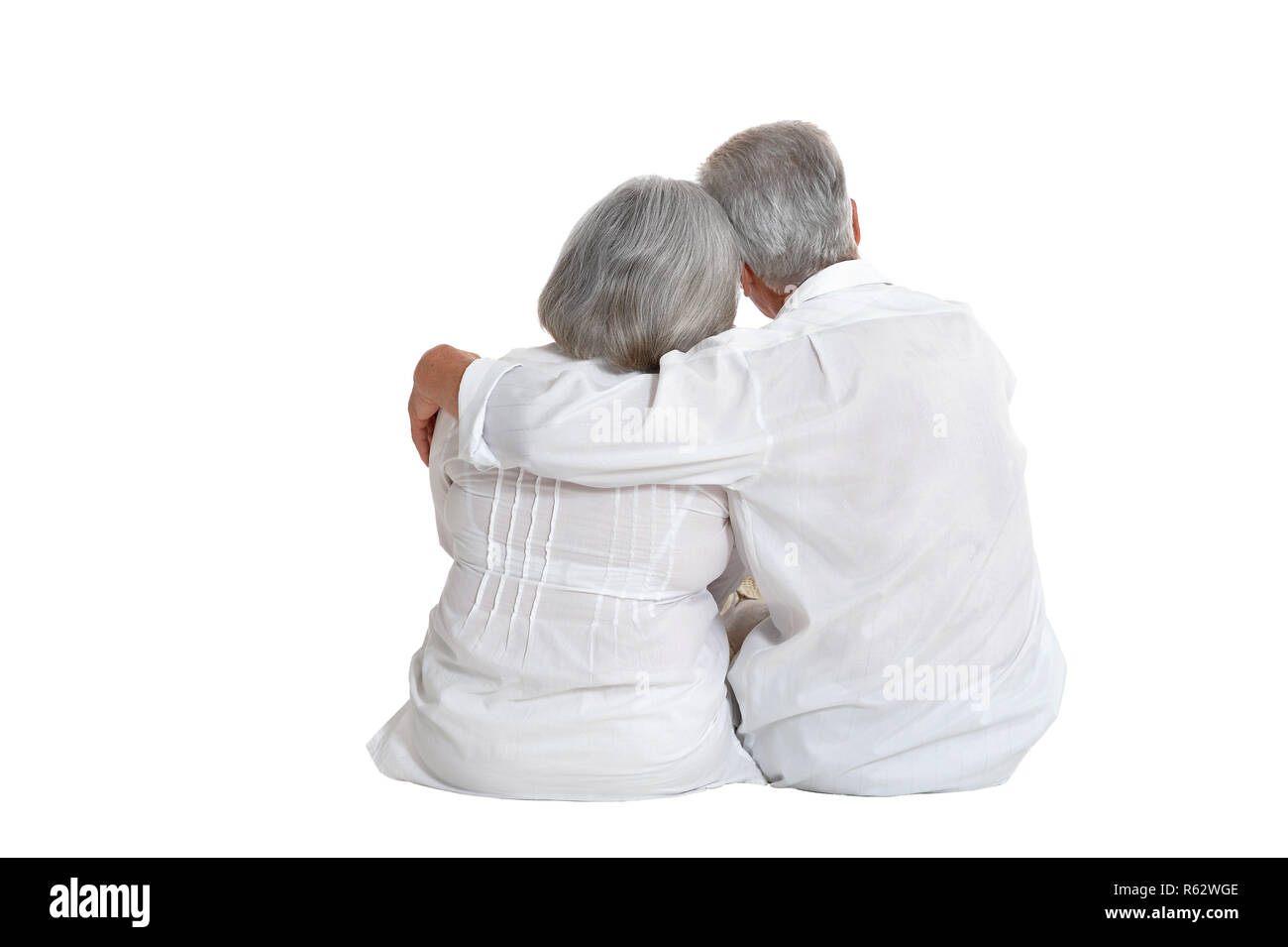 Rear view of senior couple hugging on white background Stock Photo - Alamy