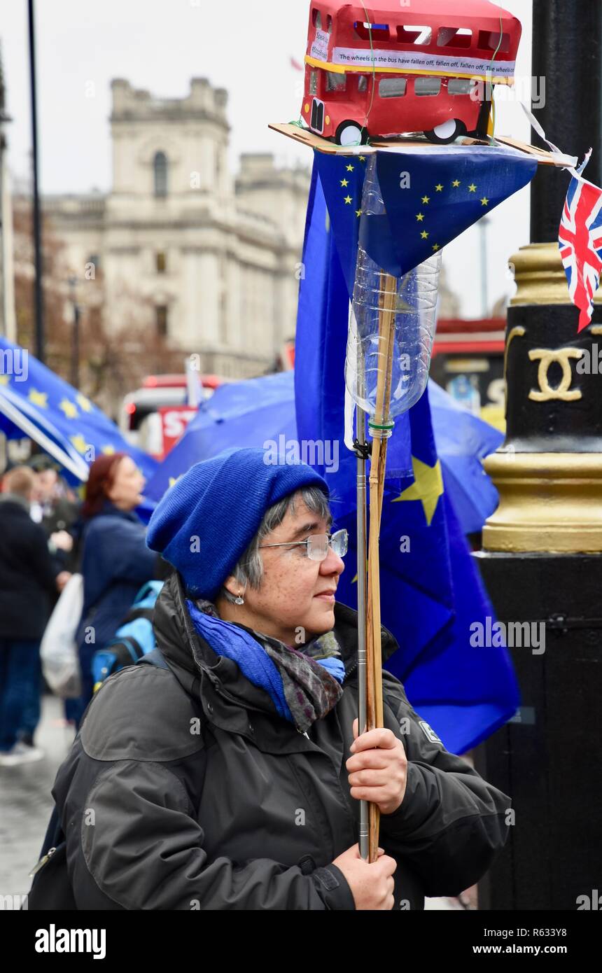 Anti Brexit protester with a "the wheels are coming off" model bus ...