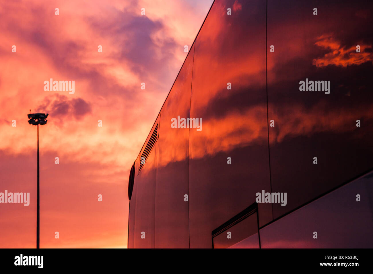 Sunset sky reflected on the window of the bus Stock Photo - Alamy