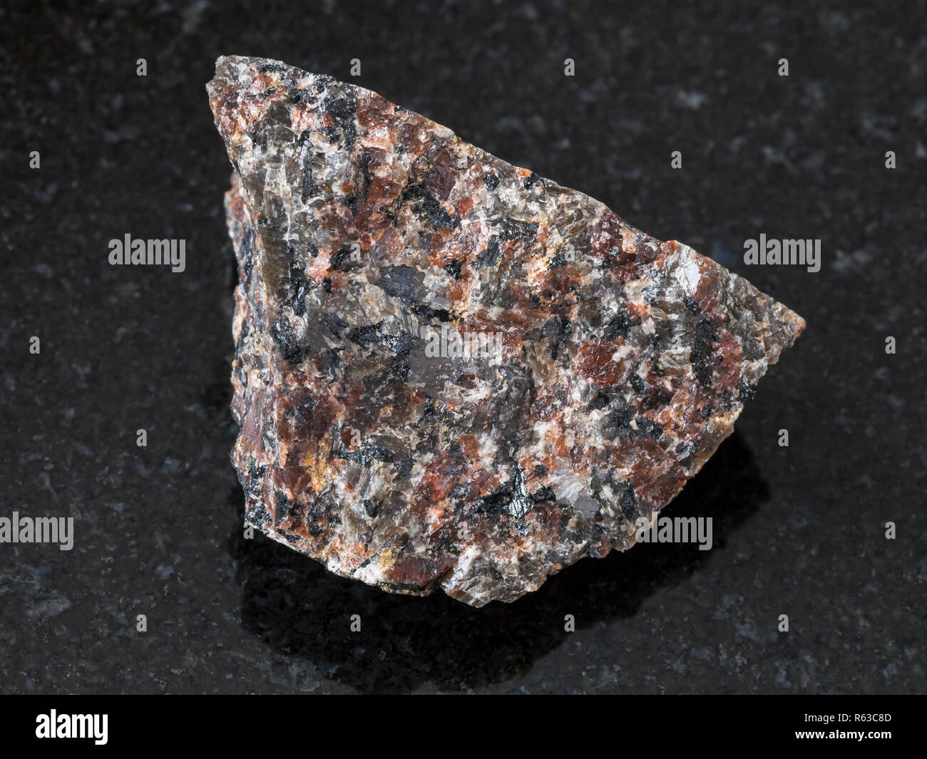 rough spreusteined urtite stone on dark Stock Photo - Alamy