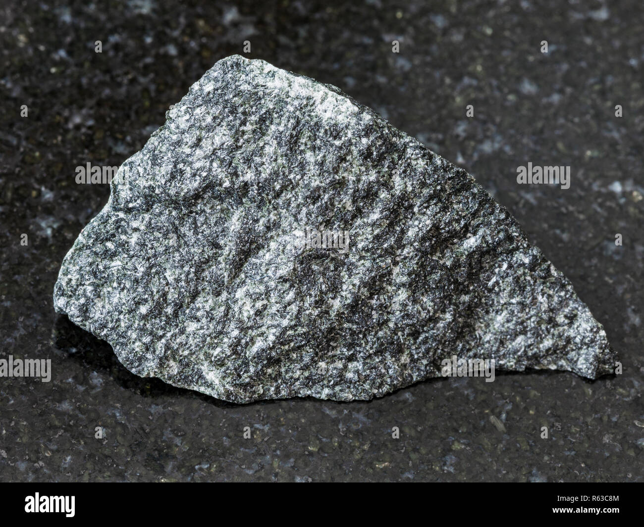 rough dolerite stone on dark background Stock Photo - Alamy
