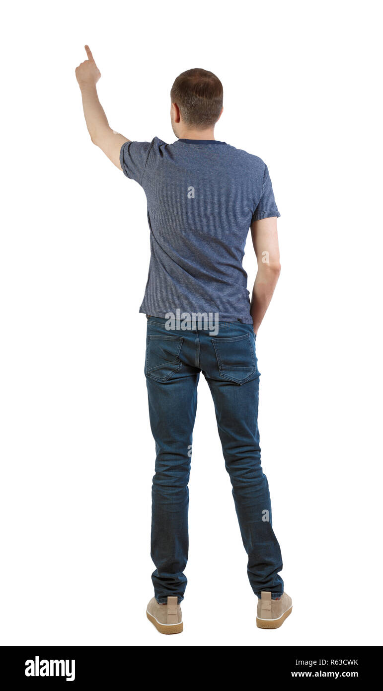 Back view of a man in jeans points his hand upwards. Rear view people ...