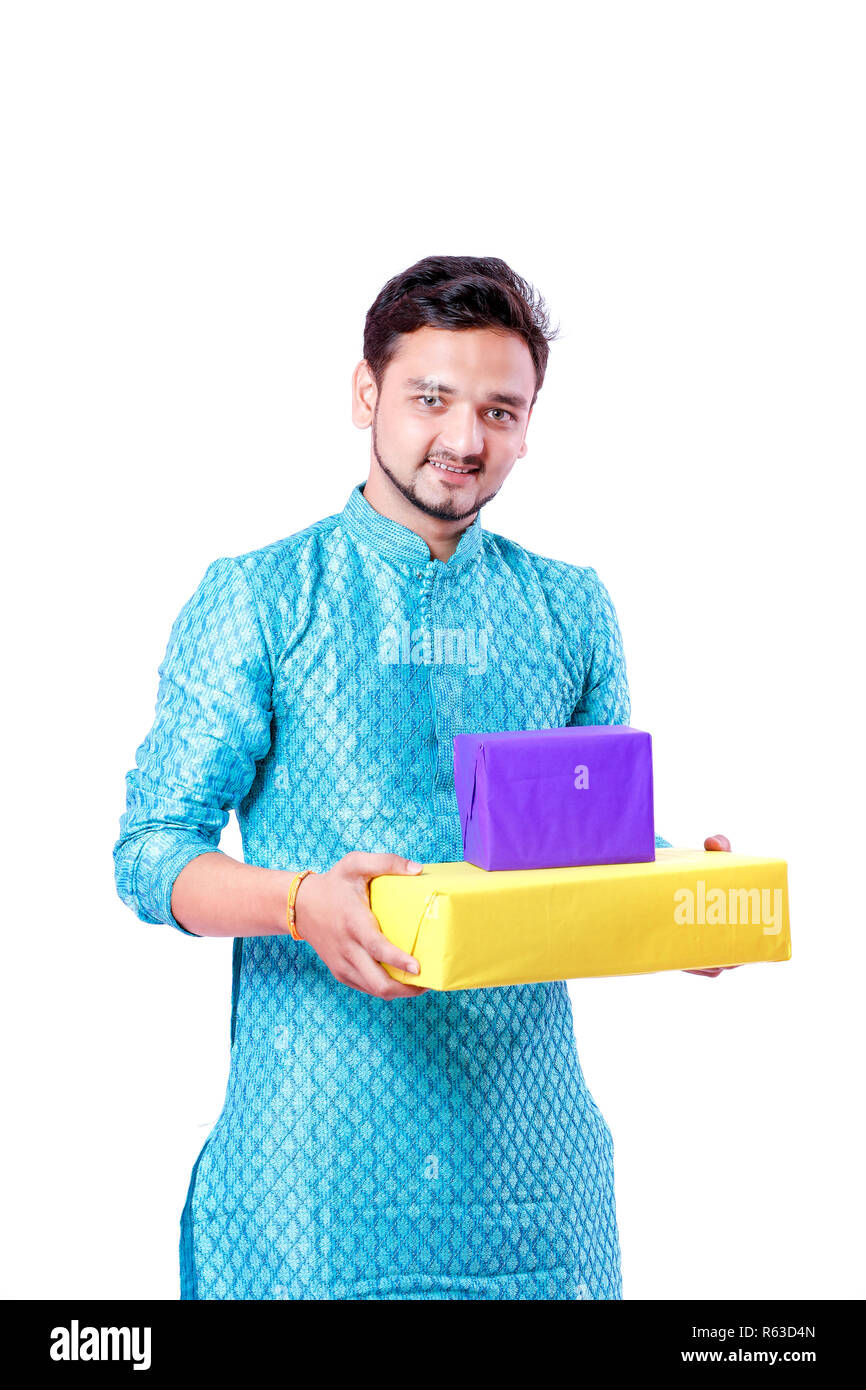 Indian man in ethnic wear and Holding gift box in hand , isolated over ...