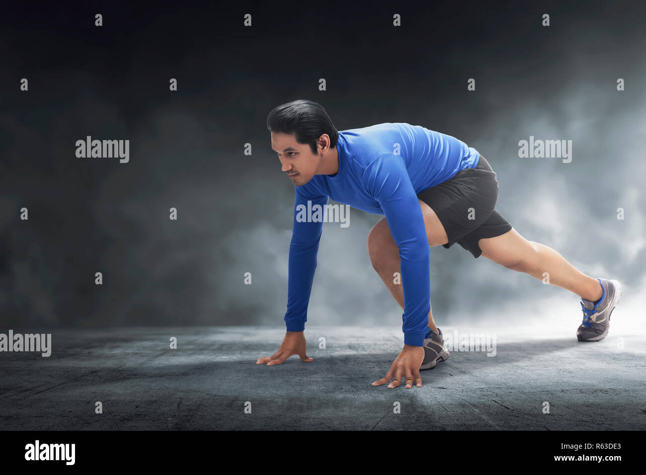 Muscular asian man ready for run Stock Photo - Alamy