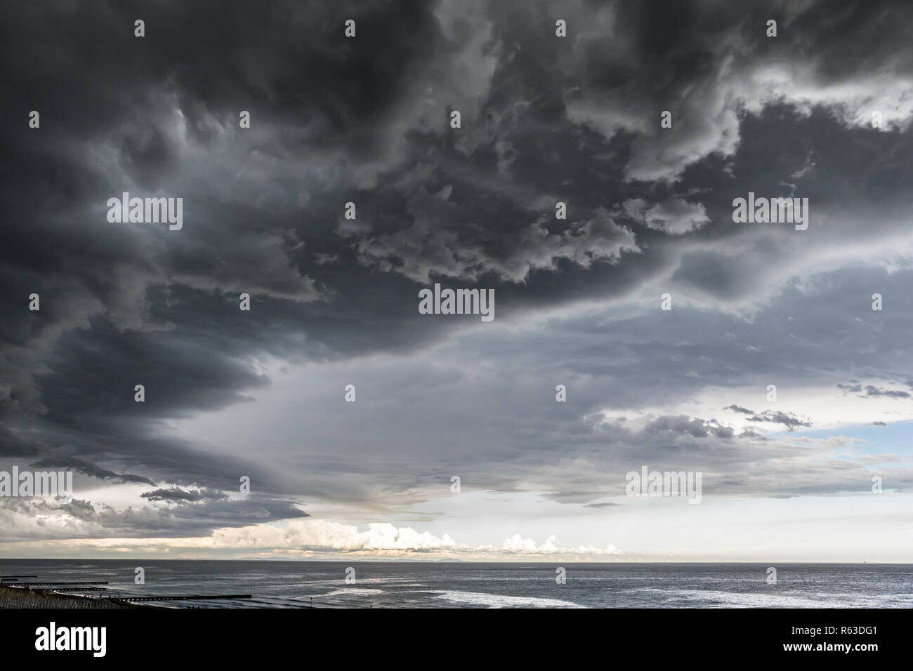 Approaching storm cloud with rain over the sea Stock Photo - Alamy