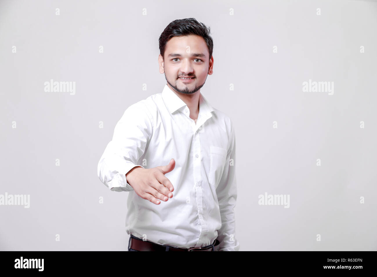 young indian man making a deal over isolated white background Stock ...