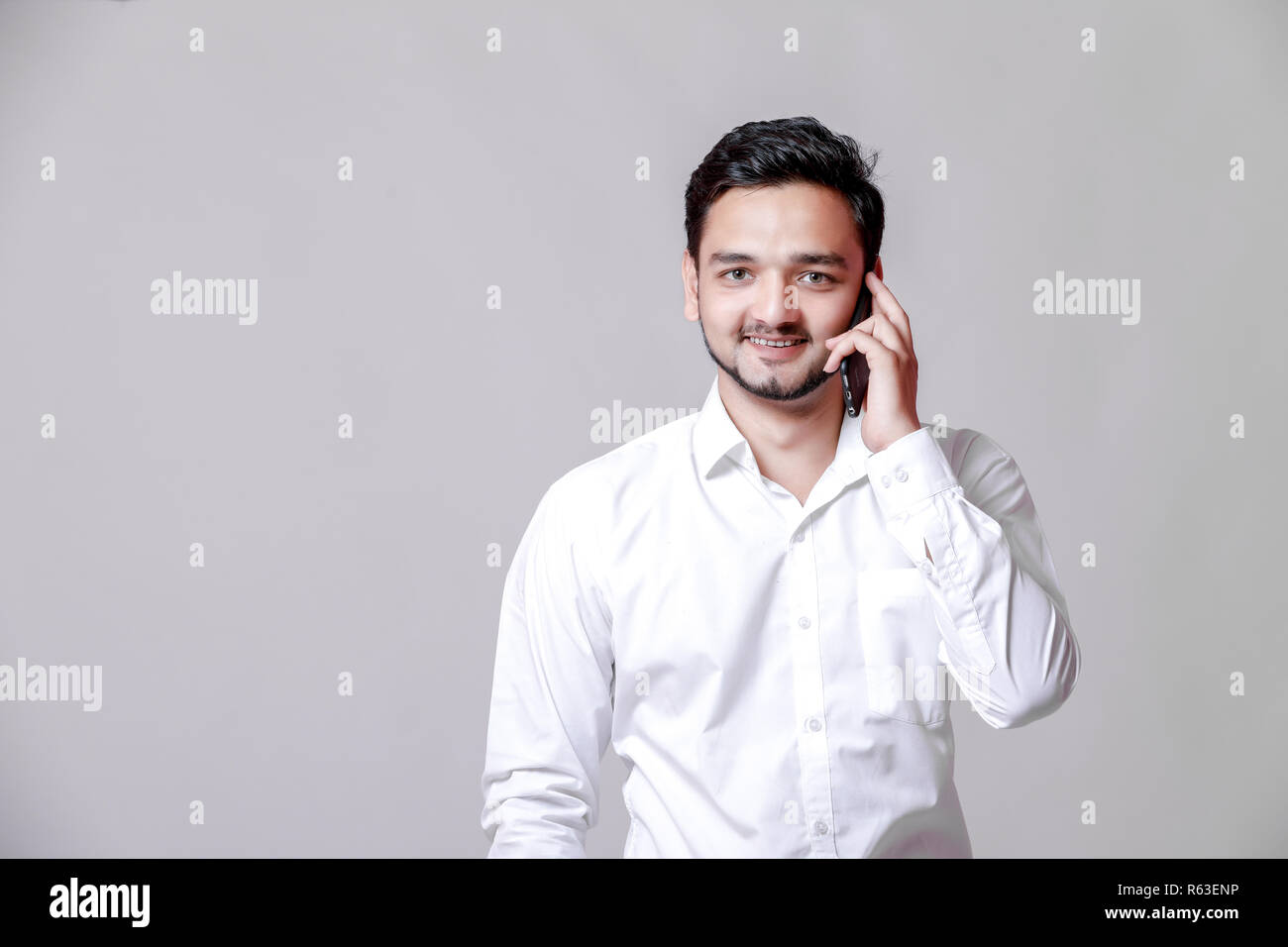 Young indian man using mobile Stock Photo - Alamy