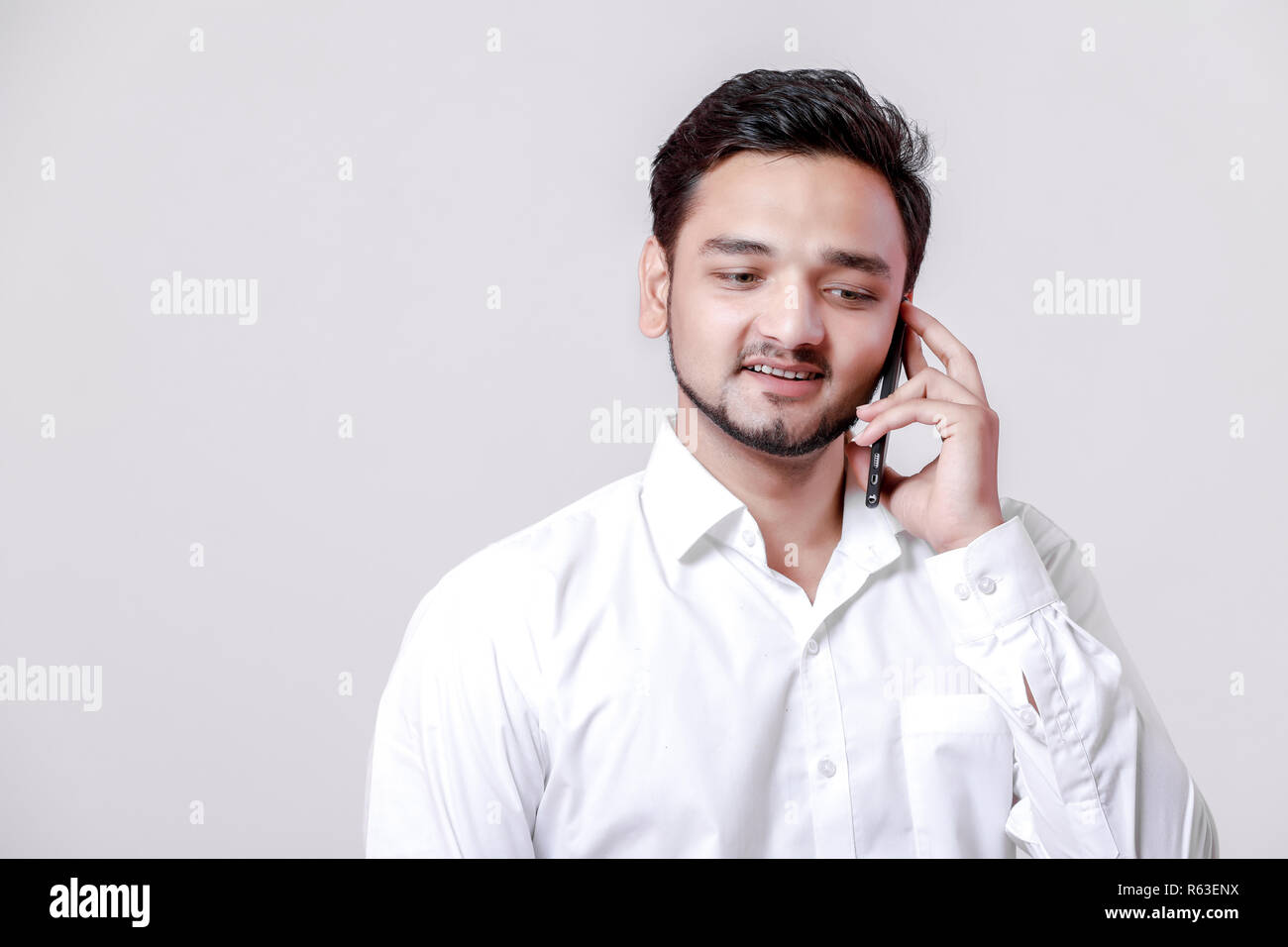 Young indian man using mobile Stock Photo - Alamy